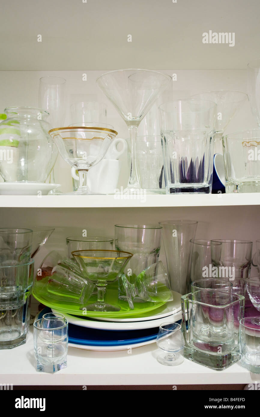 Messy glass kitchen cupboard Stock Photo - Alamy