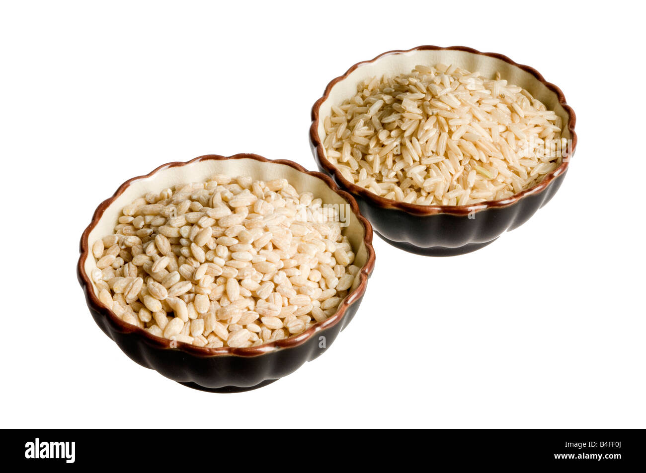 Two bowls of barley and brown rice Stock Photo - Alamy