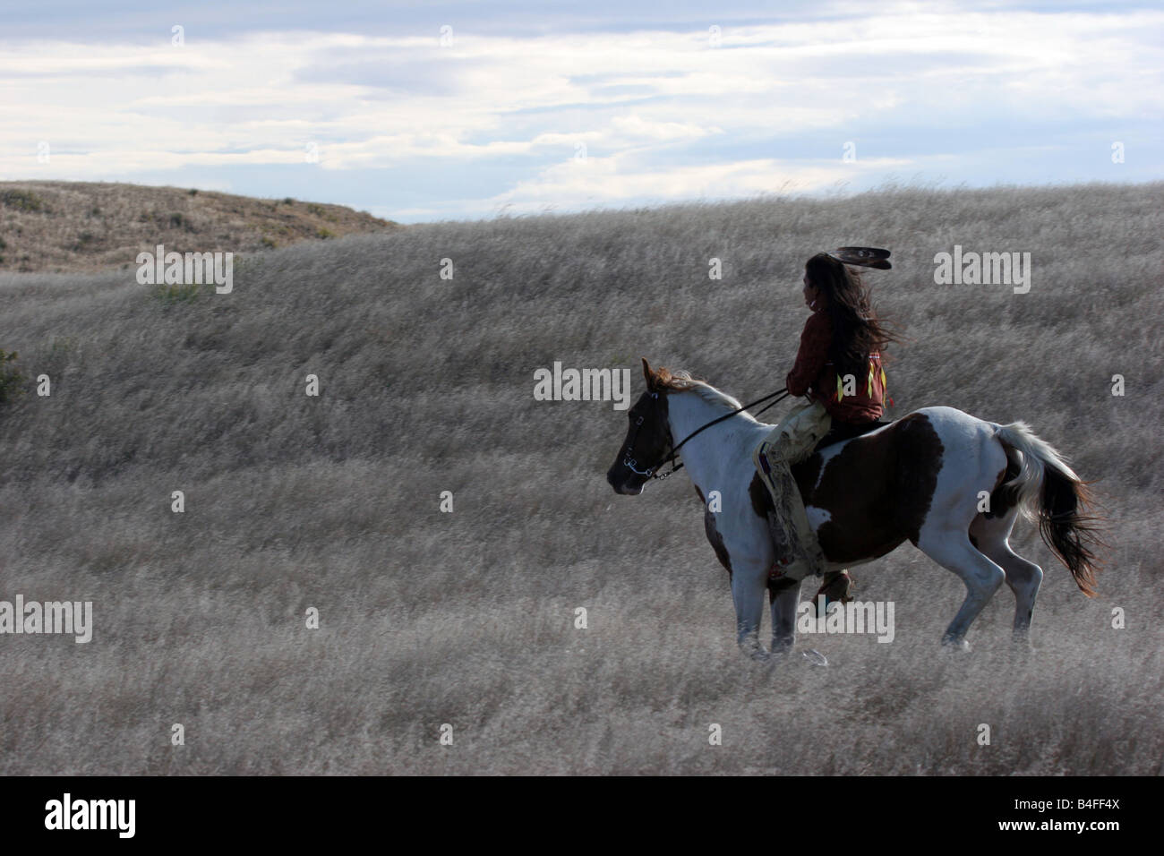 A Native American Indian riding horseback on the prairie of South ...