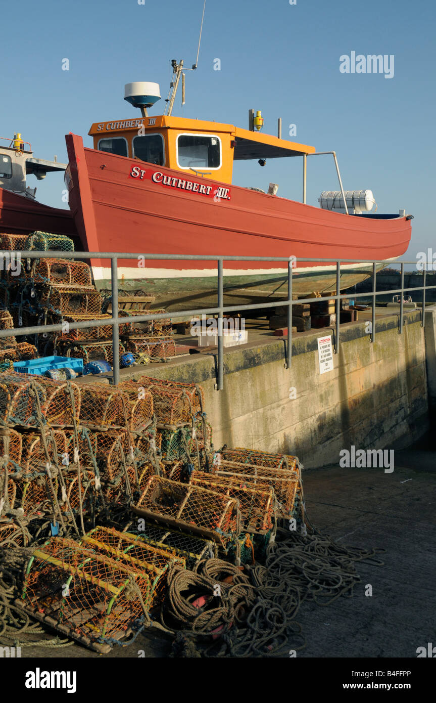 Fishing boat, lobster pots and crab pots on the quayside at Seahouses ...