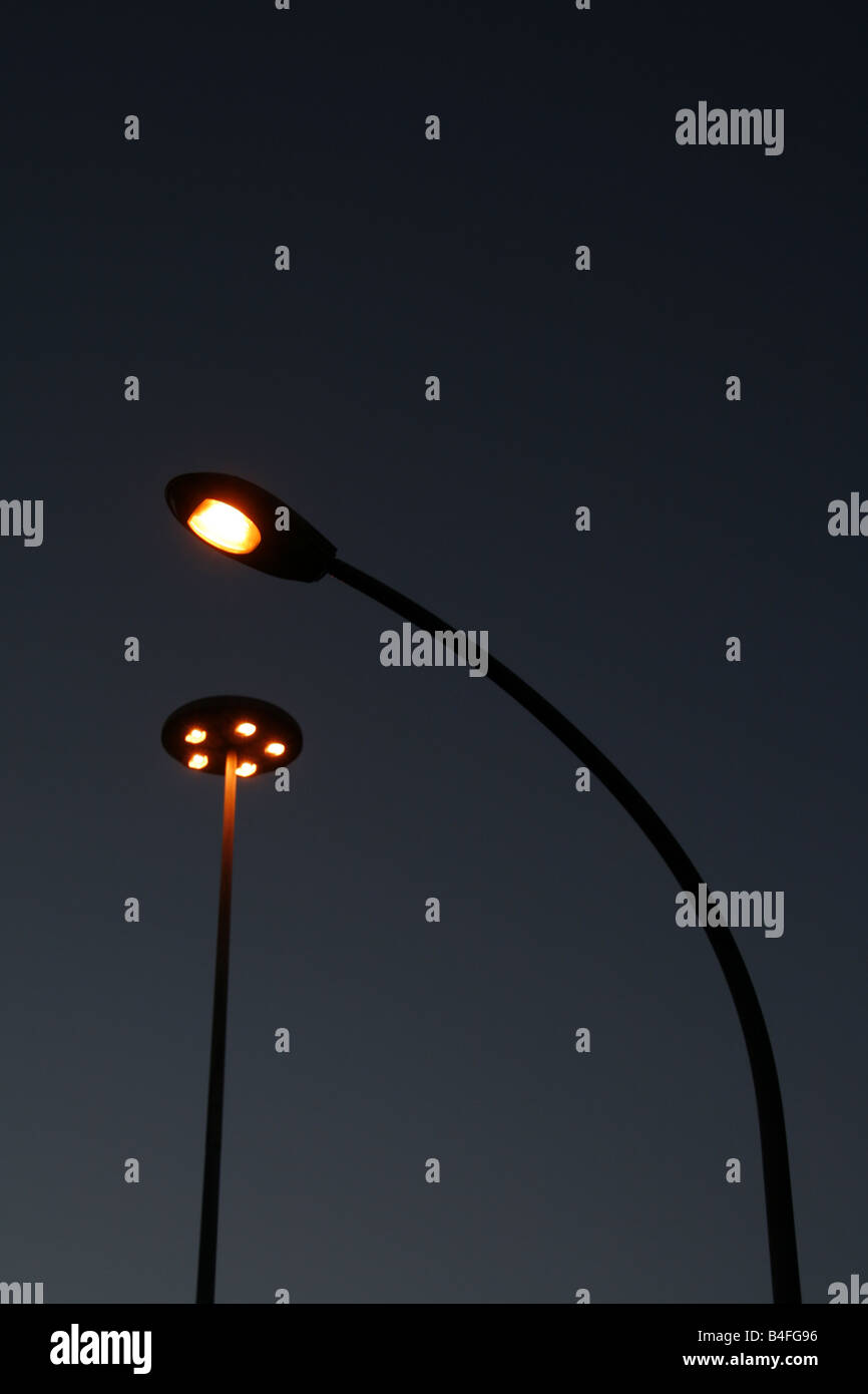 modern lamp posts in city street at night Stock Photo - Alamy