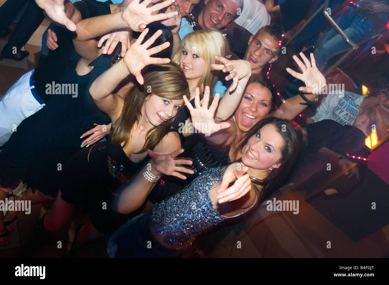 group of young people dancing and enjoying inside a night club Stock ...
