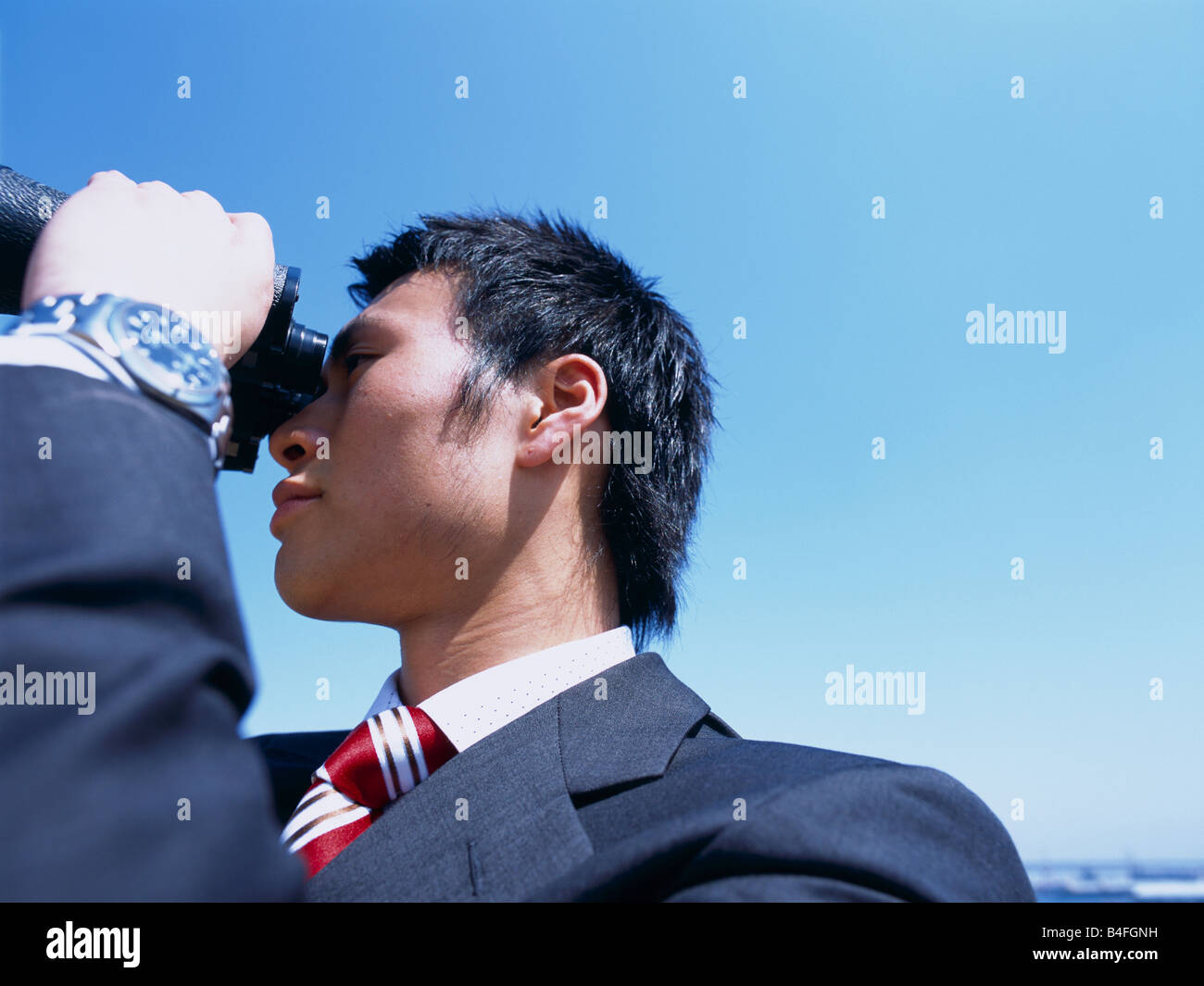 Man at an installation looking through binoculars Stock Photo - Alamy