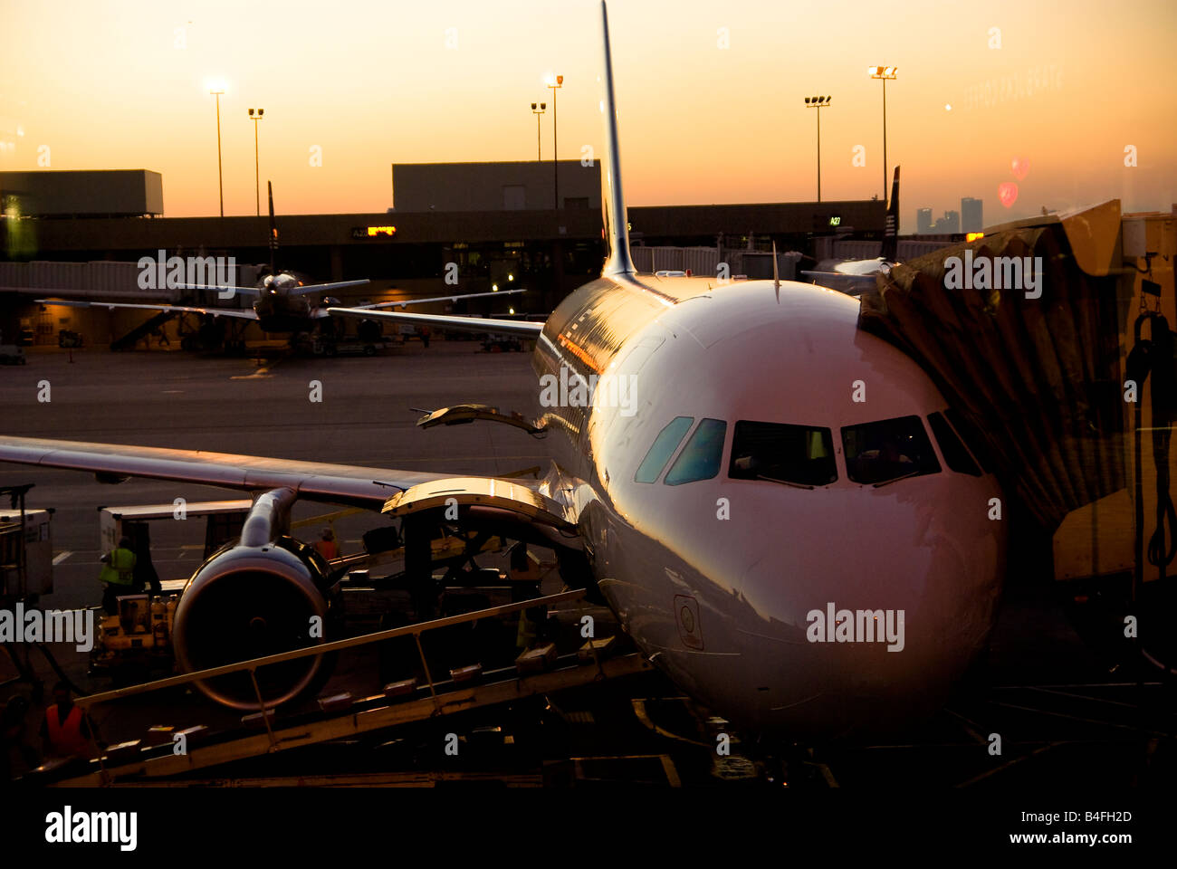 Boeing 737 standing at a gate in orange sunset Sky Harbor airport ...