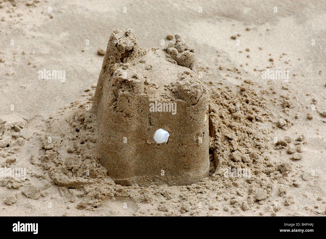 A sandcastle decorated with a shell built on Southport beach UK Stock ...