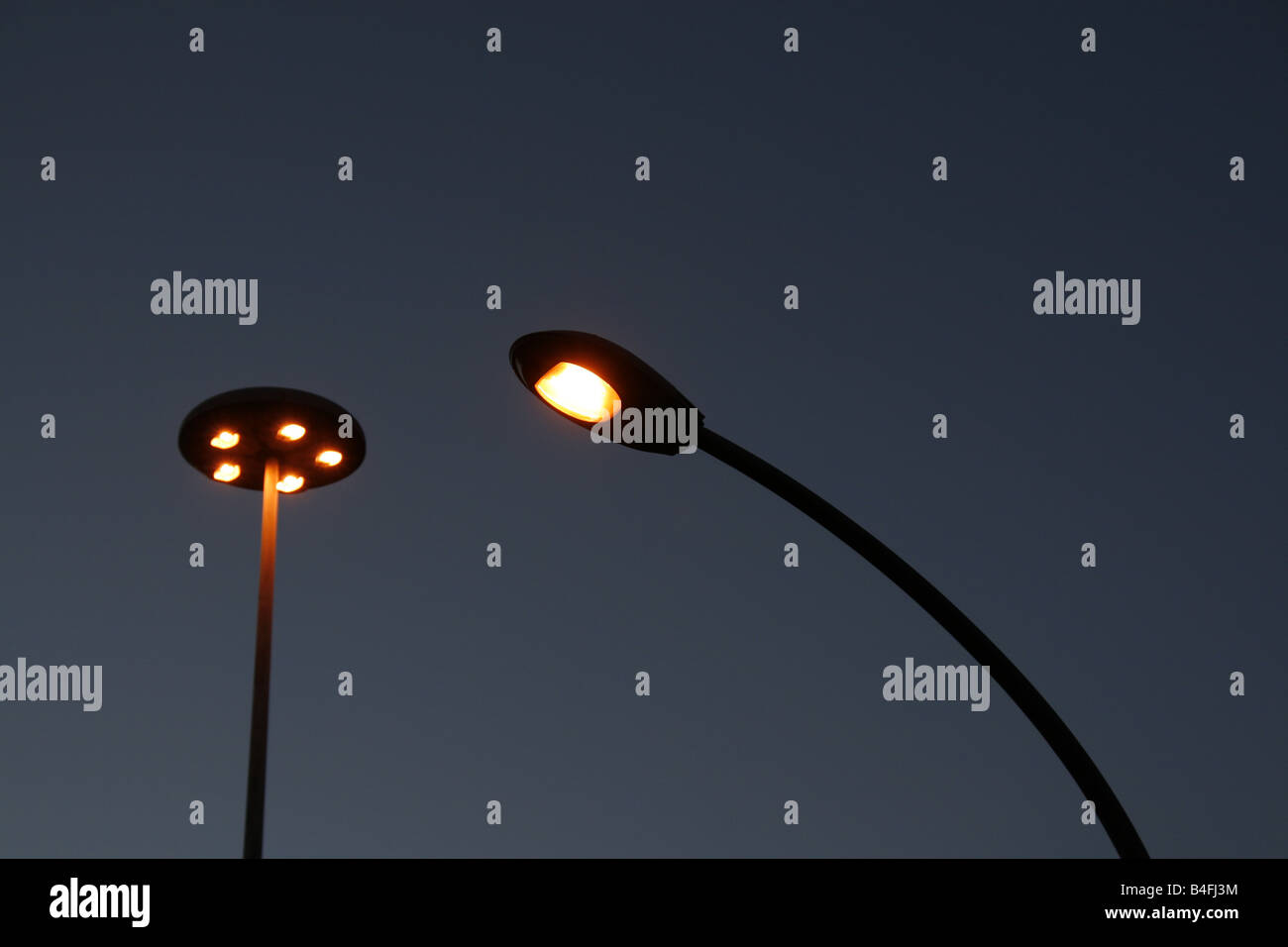 modern lamp posts in city street at night Stock Photo - Alamy