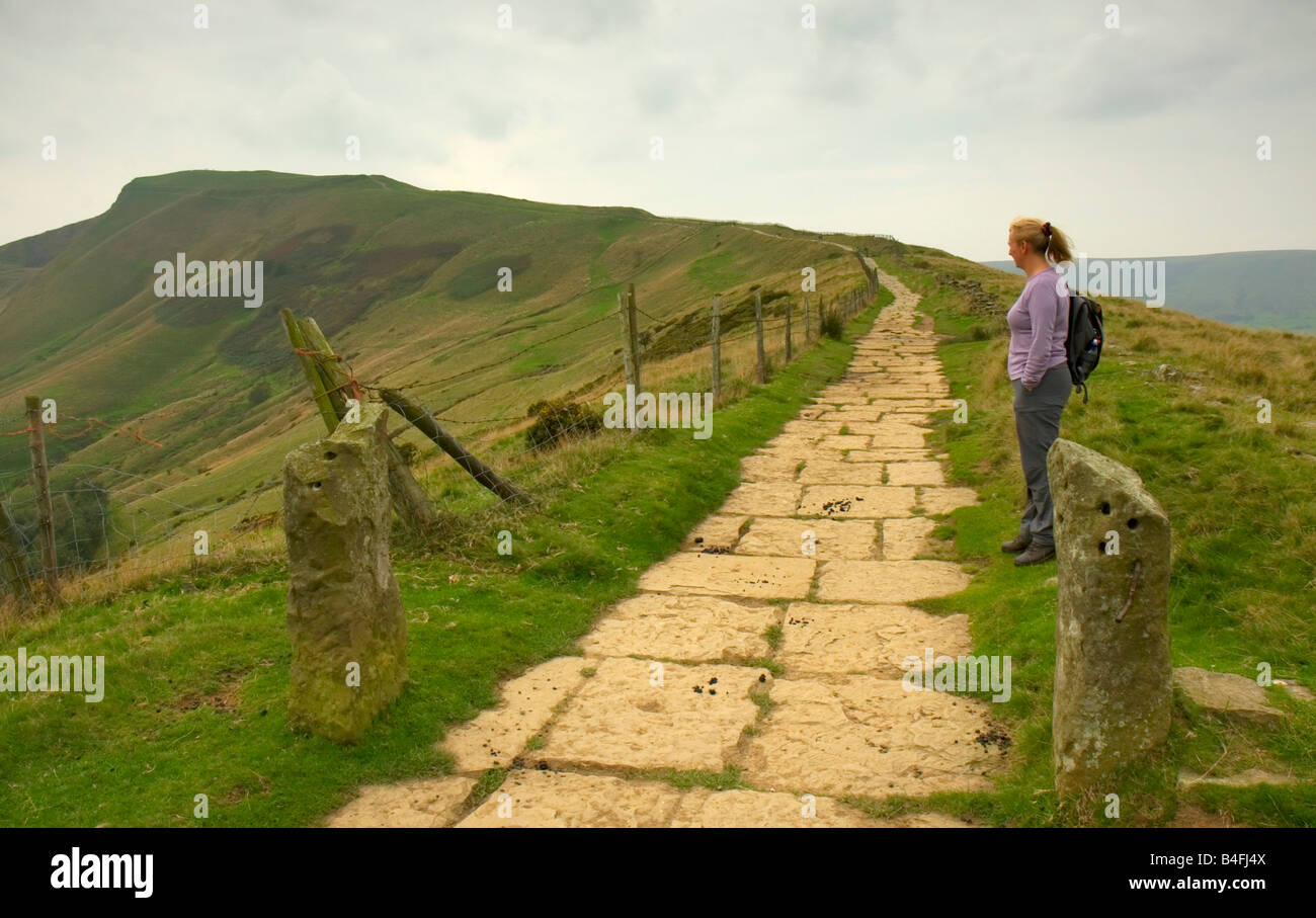 A woman looking at the path to Mam Tor near Castleton Derbyshire Peak ...