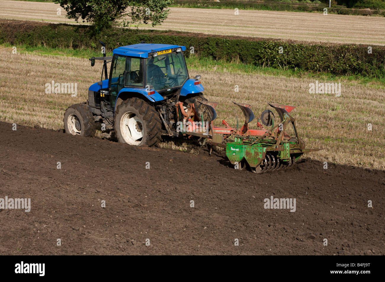 Ploughing up a stubble field ready to plant Barley with a New Holland ...