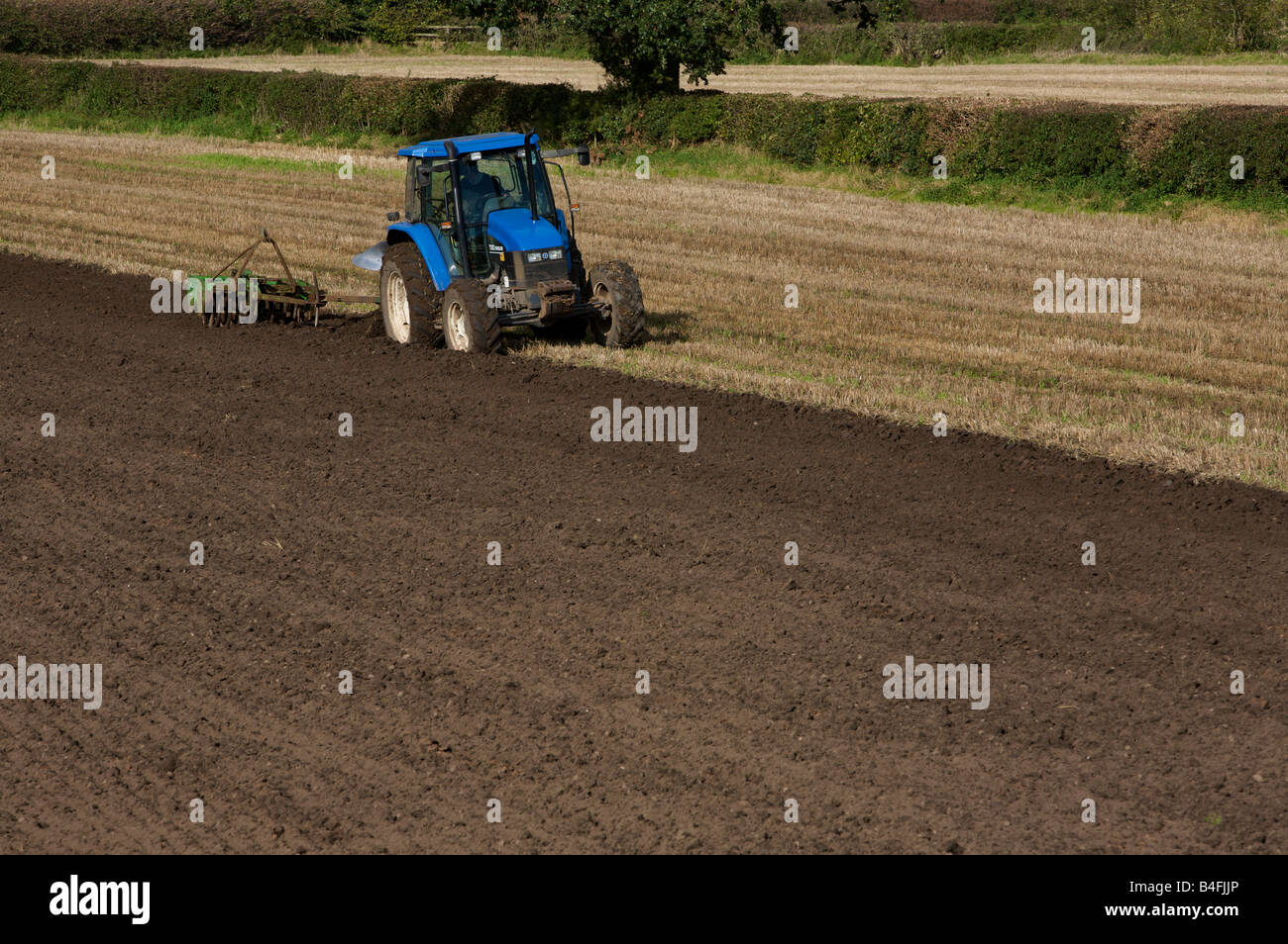 Ploughing up a stubble field ready to plant Barley with a New Holland ...