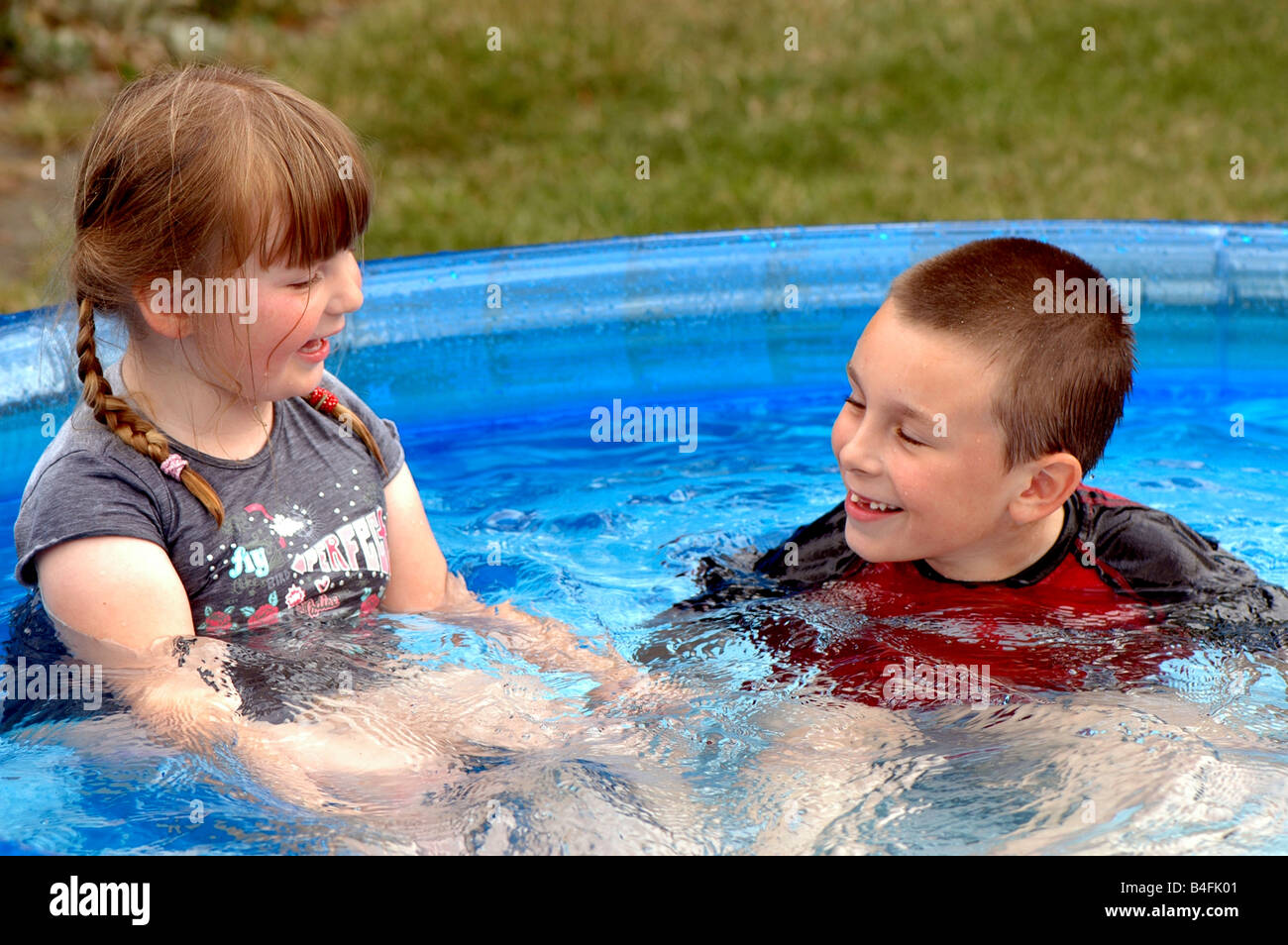 Brother And Sister Playing In Pool High Resolution Stock Photography ...