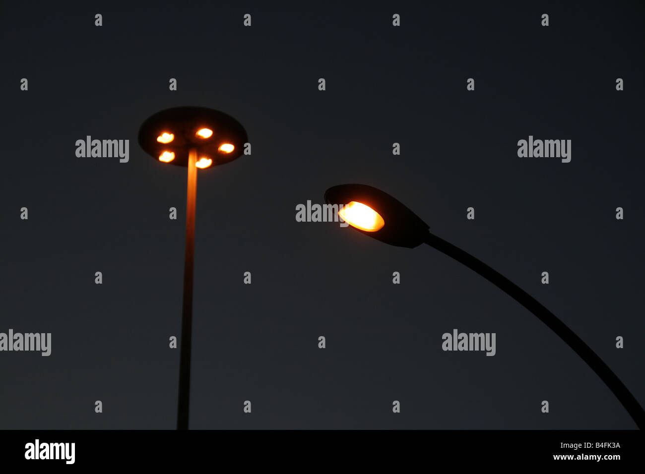 modern lamp posts in city street at night Stock Photo - Alamy