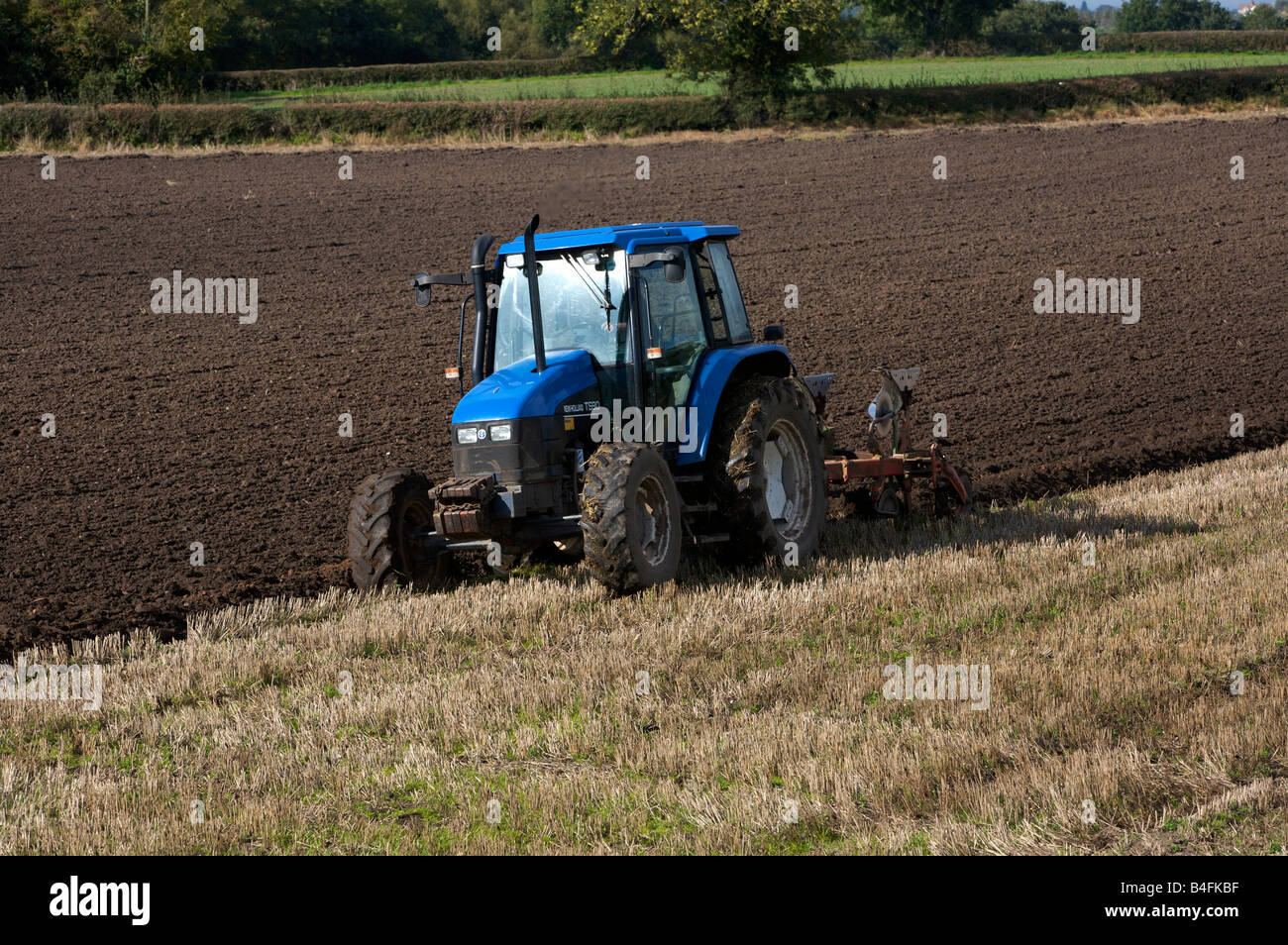 Ploughing up a stubble field ready to plant Barley with a New Holland ...