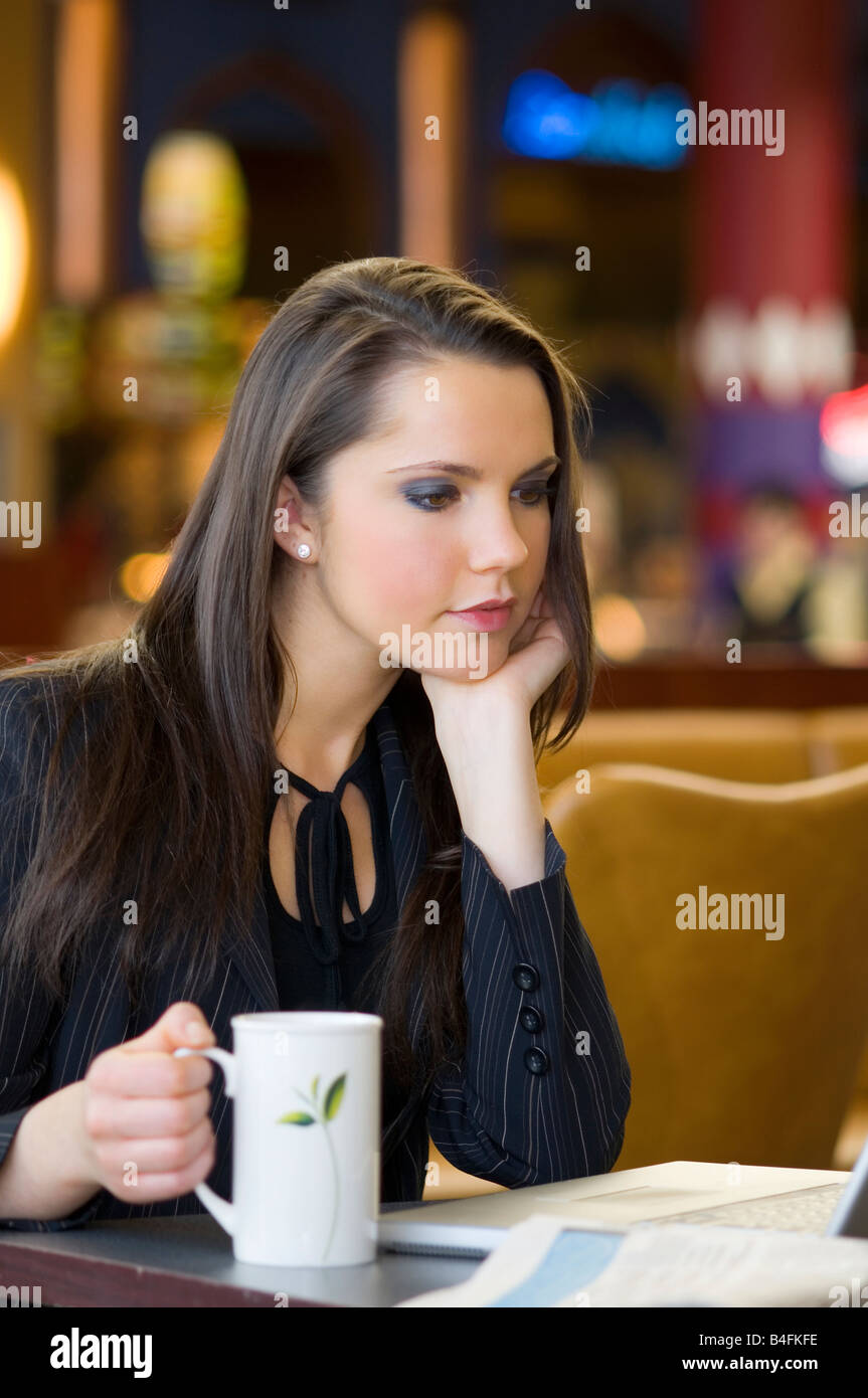 young business woman taking a cup of tea sitting in a bar Stock Photo ...