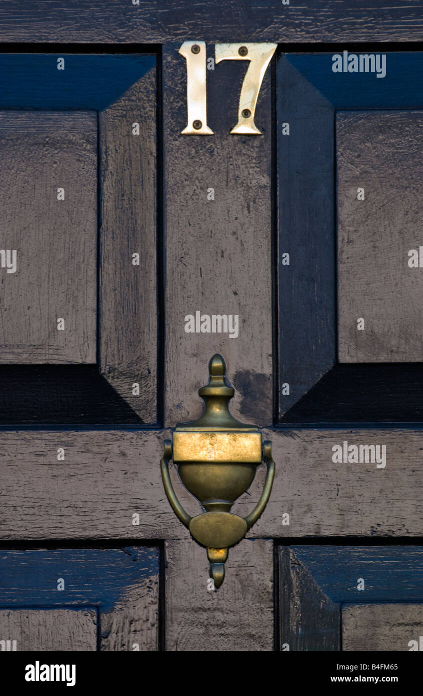Detail of black wooden front door showing number 17 and knocker of ...