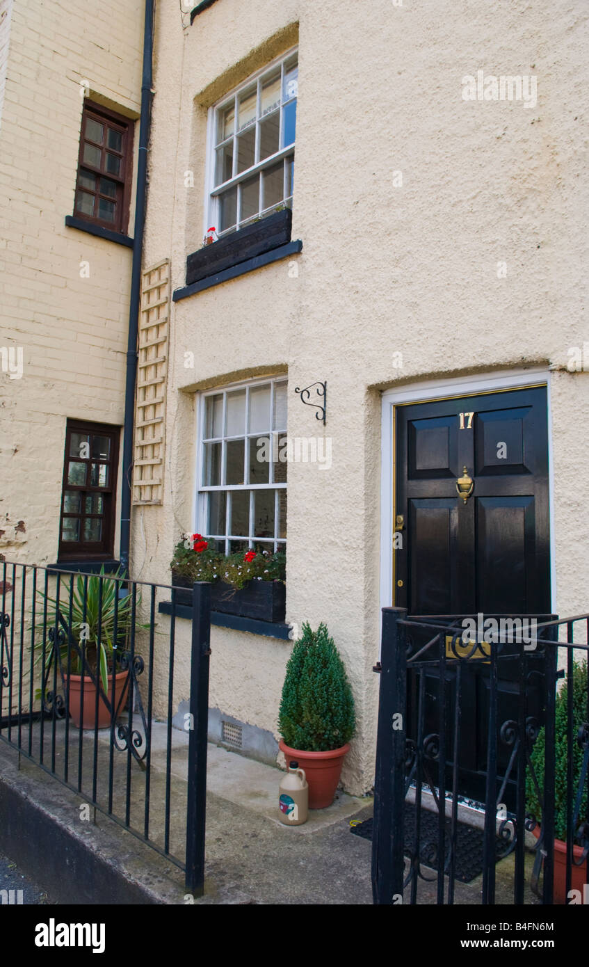 Black panelled front door with white frame of house with white sash ...