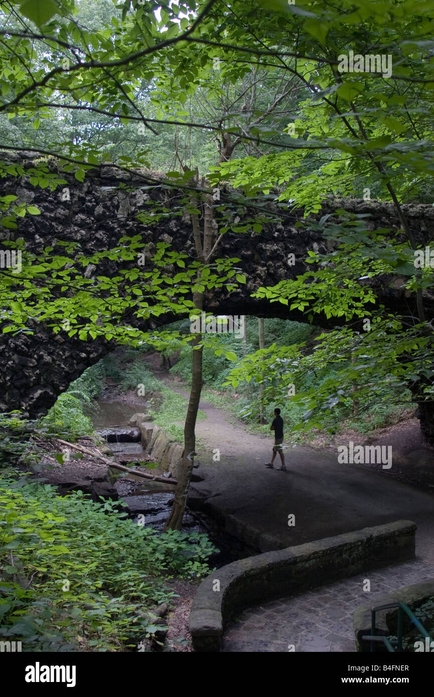 Man walking under stone bridge in Schenley Park, Oakland, Pittsburgh ...