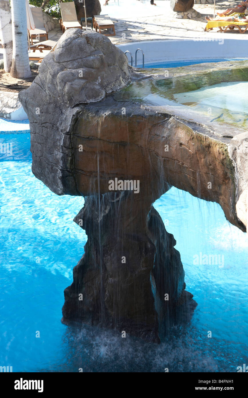 Waterfall in hotel swimming pool Stock Photo - Alamy