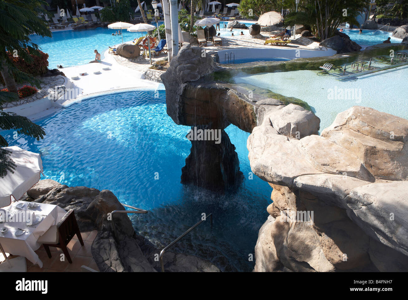 Waterfall in hotel swimming pool Stock Photo - Alamy
