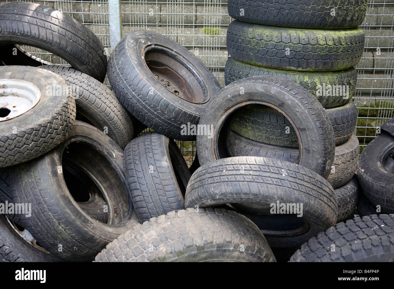 Old tyres waiting to be recycled Stock Photo - Alamy