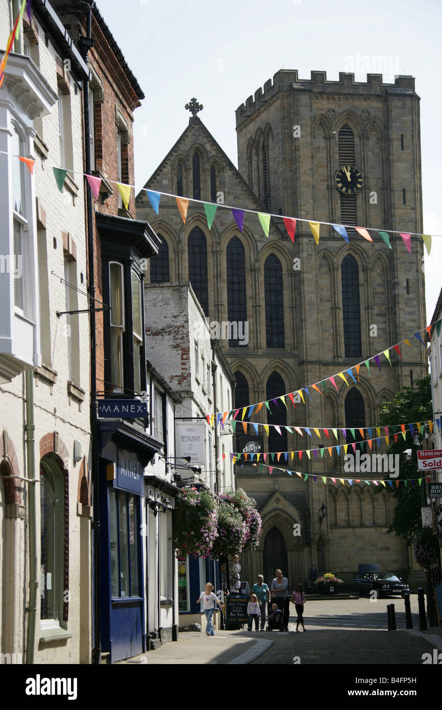 City of Ripon, England. Kirkgate Street shops with the west front of ...