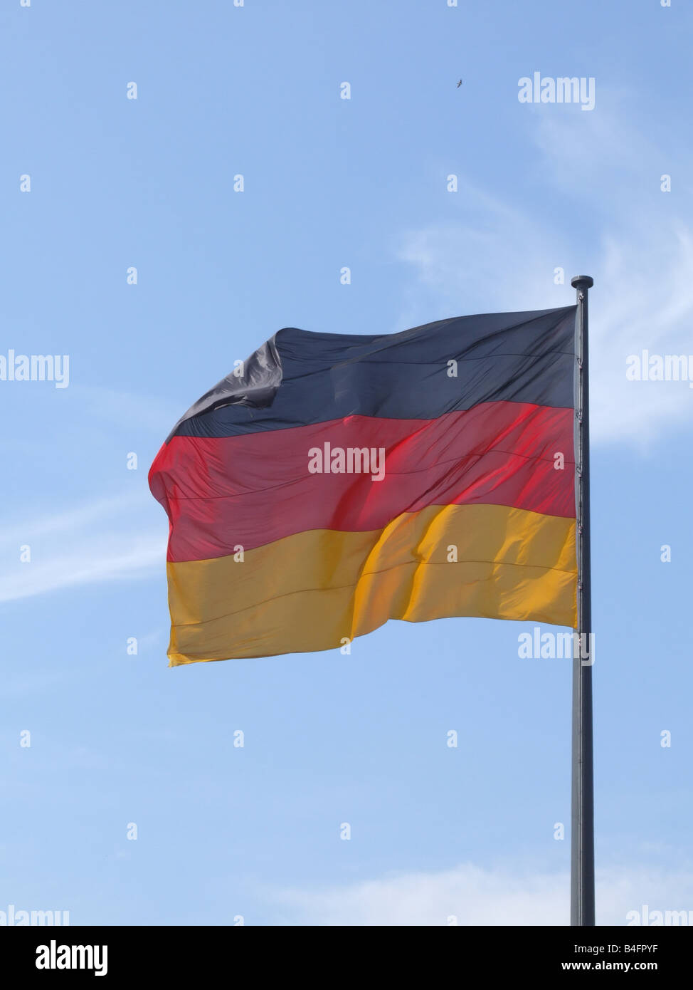 german flag flying in blue sky in berlin Stock Photo - Alamy