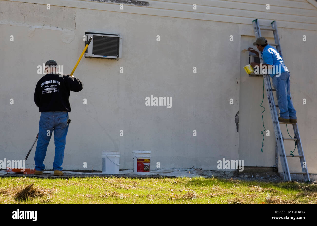 Painters painting a wall Stock Photo - Alamy