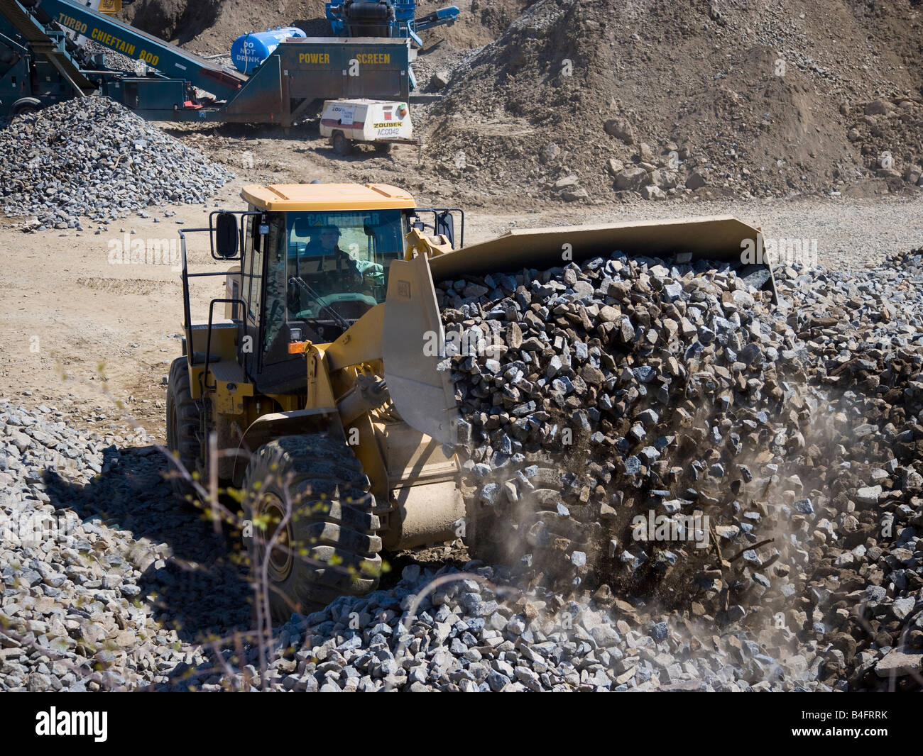 Bulldozer dumping rocks Stock Photo - Alamy