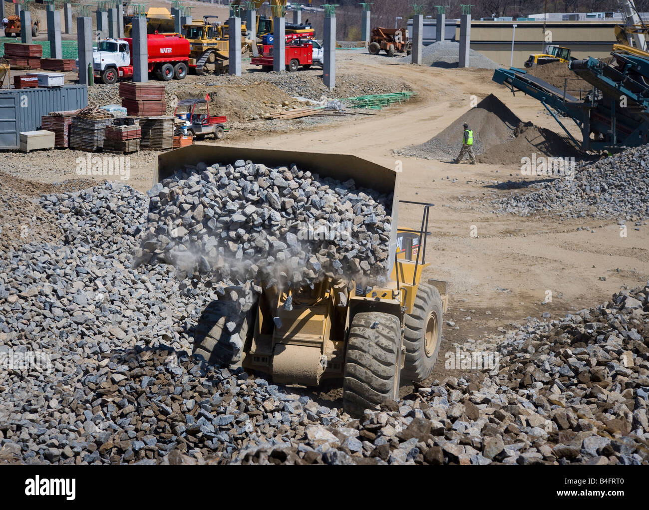 Bulldozer dumping rocks Stock Photo - Alamy