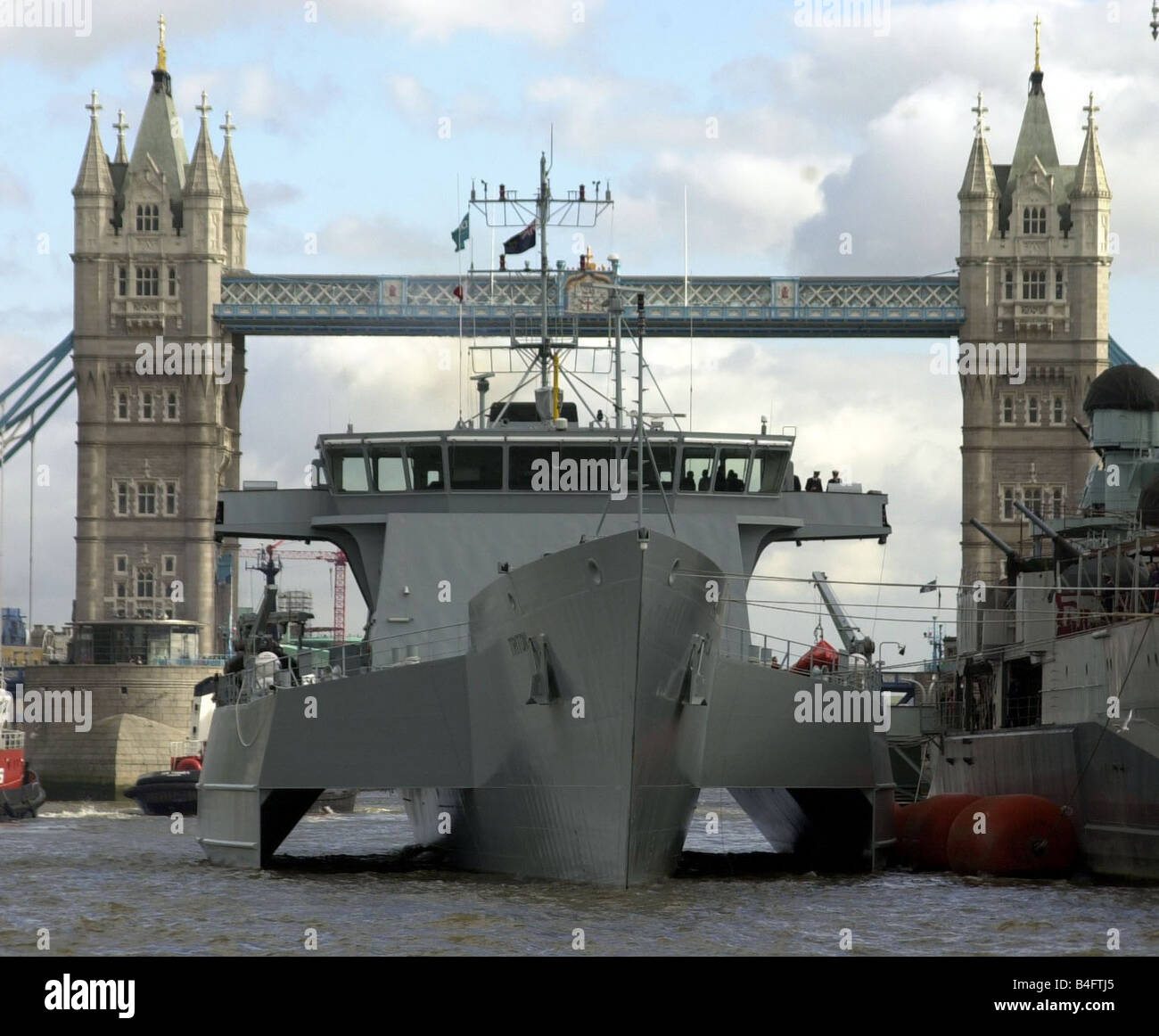 The Triton a three hulled ship tied next to the HMS Belfast by Tower ...