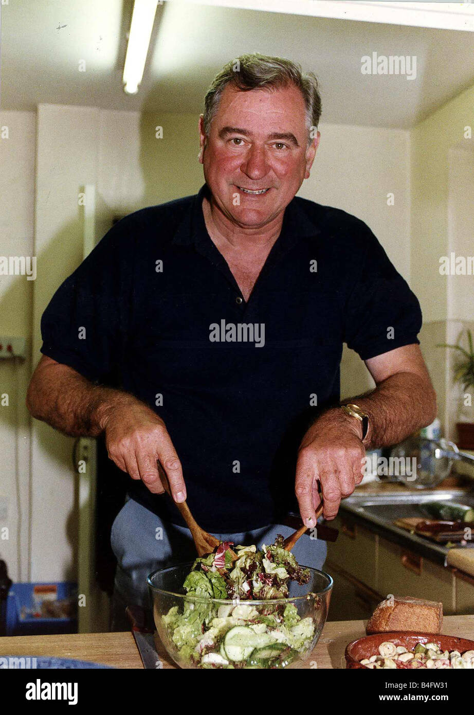 George Baker actor preparing salad in his kitchen dbase Mirrorpix Stock ...