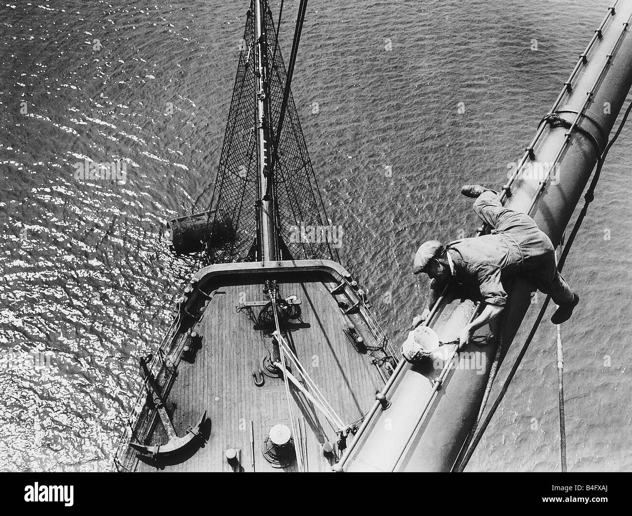 A painter painting the mast of an old sailing ship Circa 1955 Stock ...