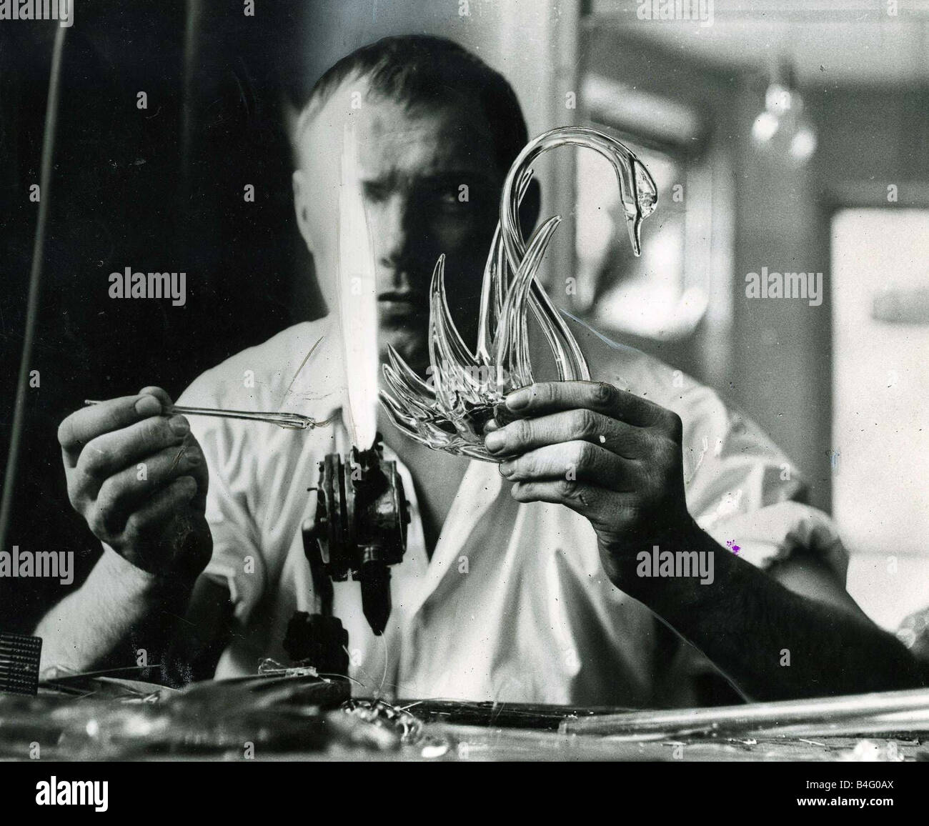 Glass blower at work finishing off a swan August 1955 Stock Photo - Alamy