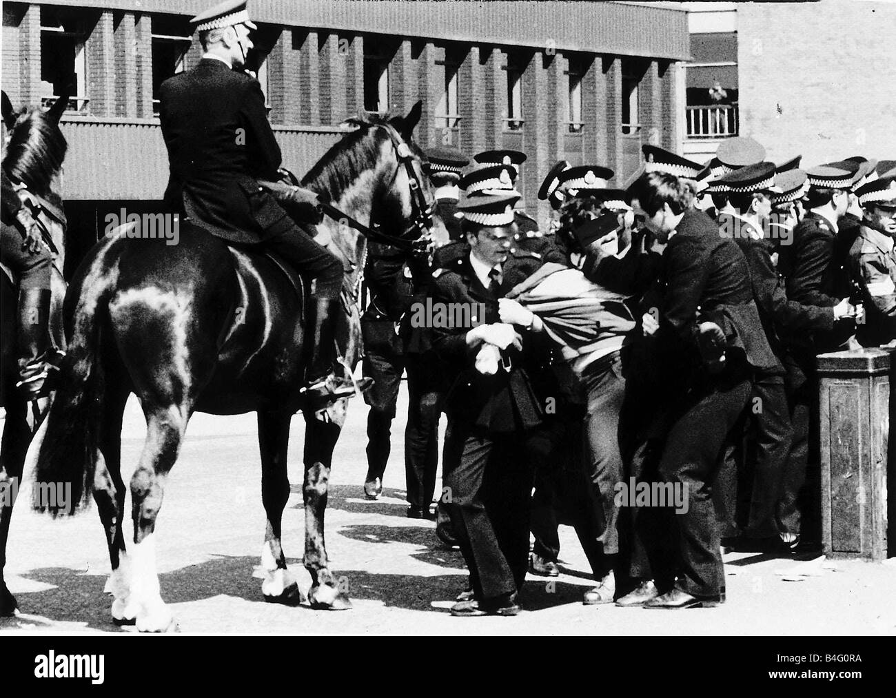 Police pulling away a protestor at a picket line outside Ravenscraig ...