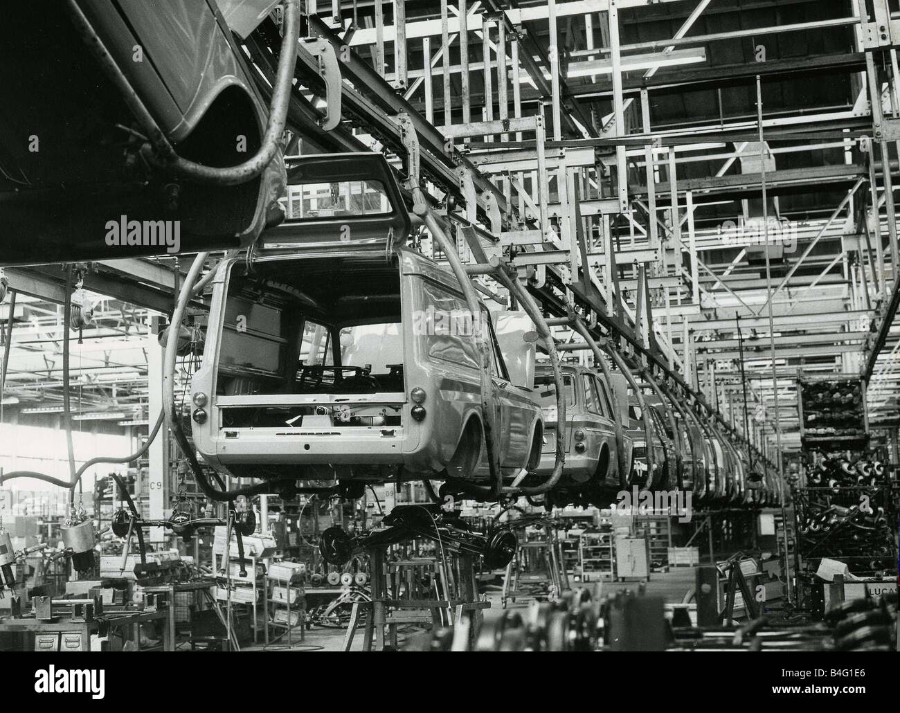 Hillman Imp cars and vans on production line hanging from cradles at ...