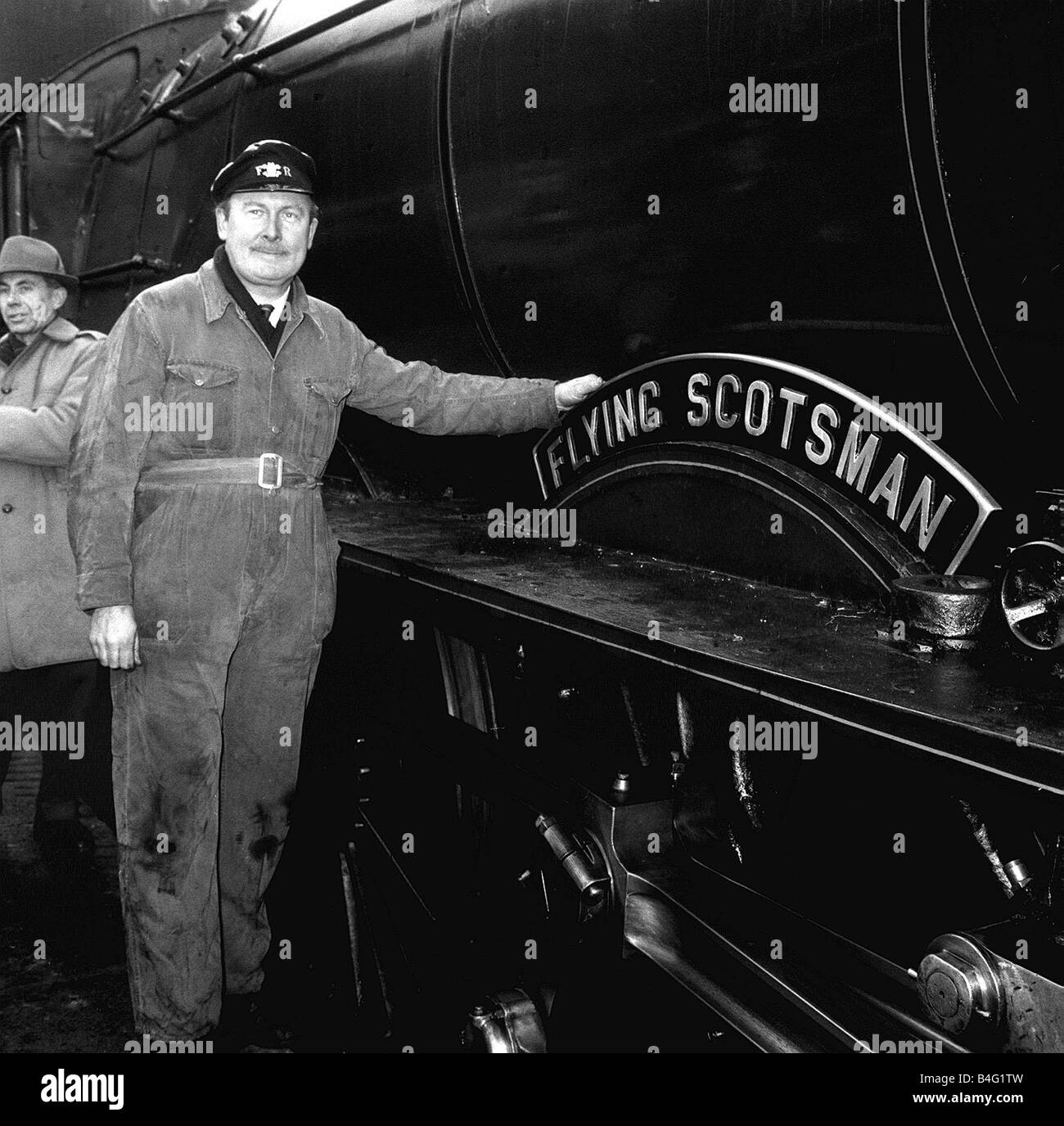 Steam train Flying Scotsman with owner Alan Pegler seen here standing beside the name plate in ...
