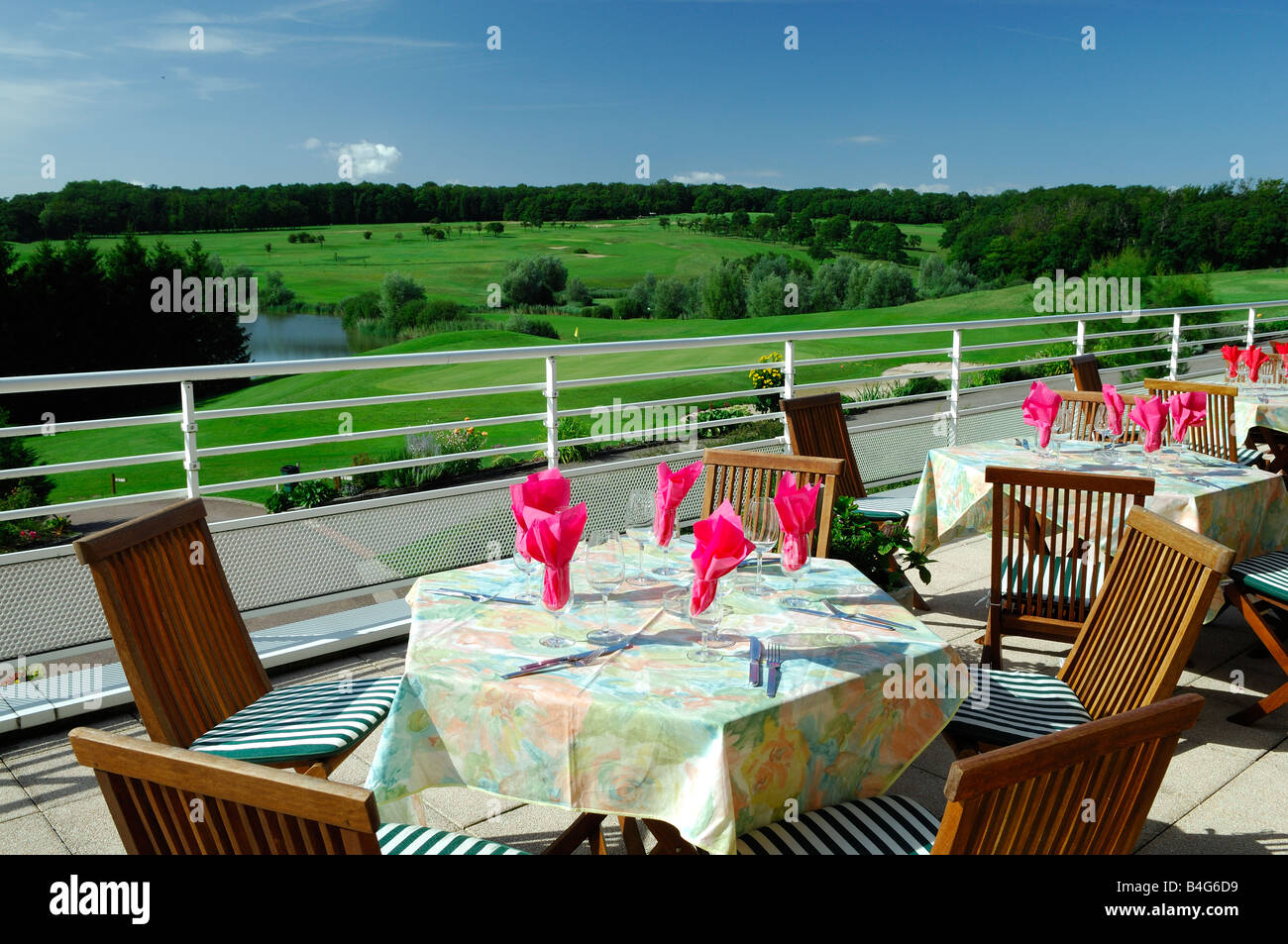 Restaurant tables with overview on background to a green golf course ...