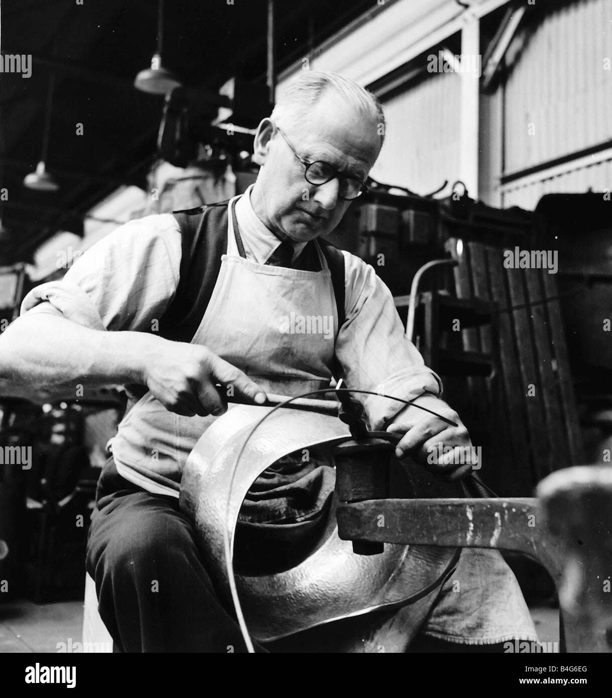 A worker at Pearson Page Jewsbury Co factory making brass ware for sale ...