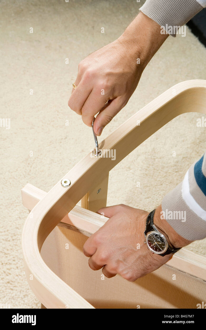 A man using an Allen wrench on a piece of furniture Stock Photo - Alamy