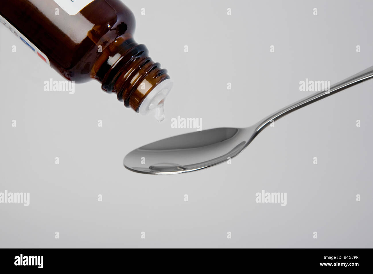 Medicine dropping onto a spoon Stock Photo - Alamy