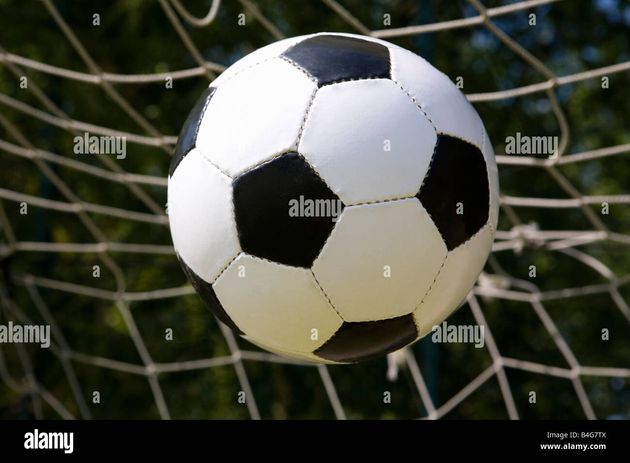 A soccer ball going into the net Stock Photo - Alamy