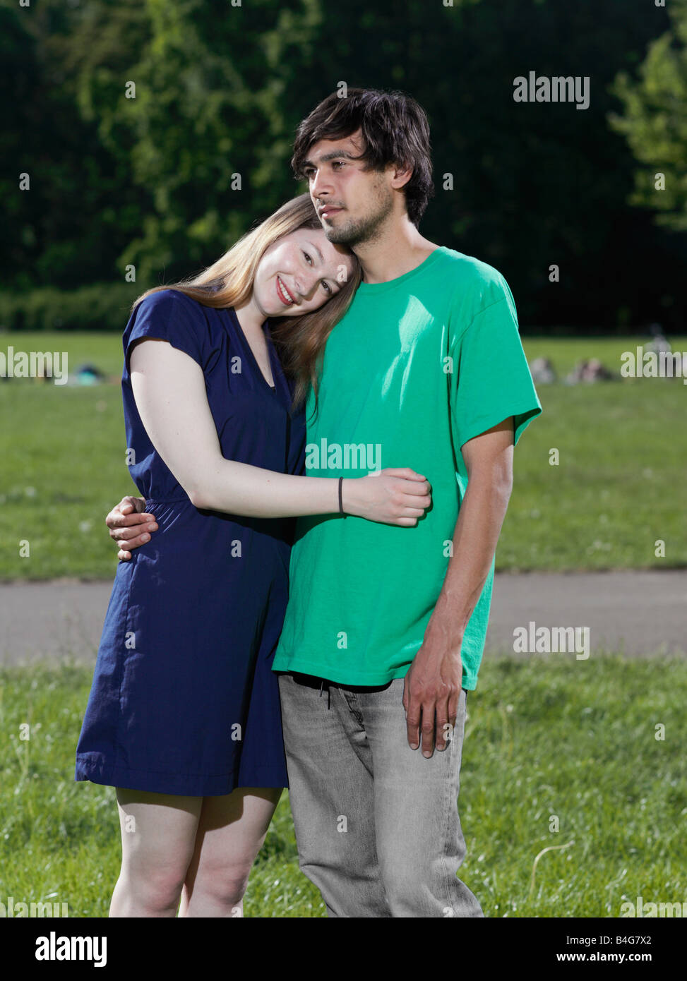 A young couple with their arms around each other Stock Photo - Alamy