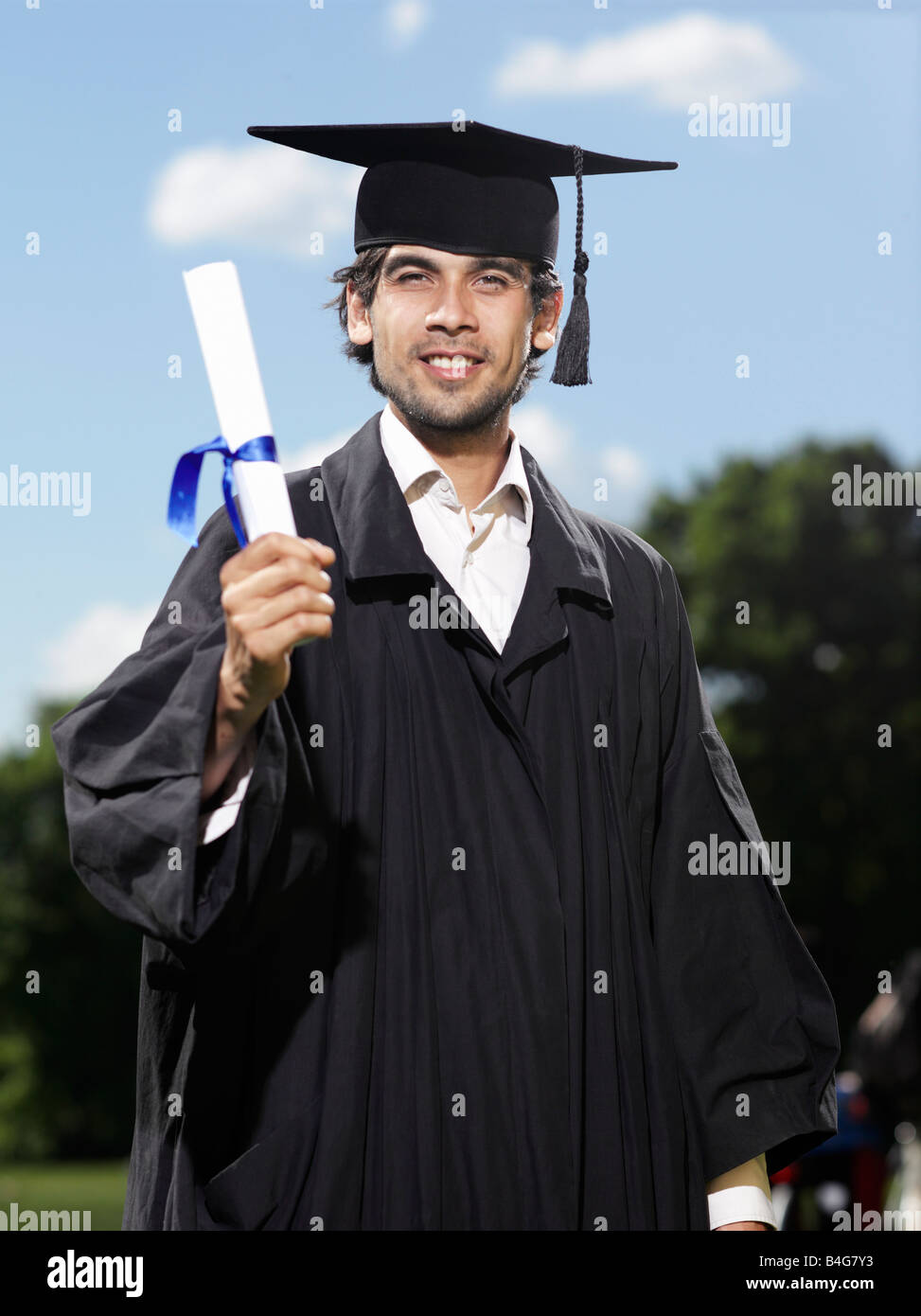 A male graduate holding a diploma Stock Photo - Alamy