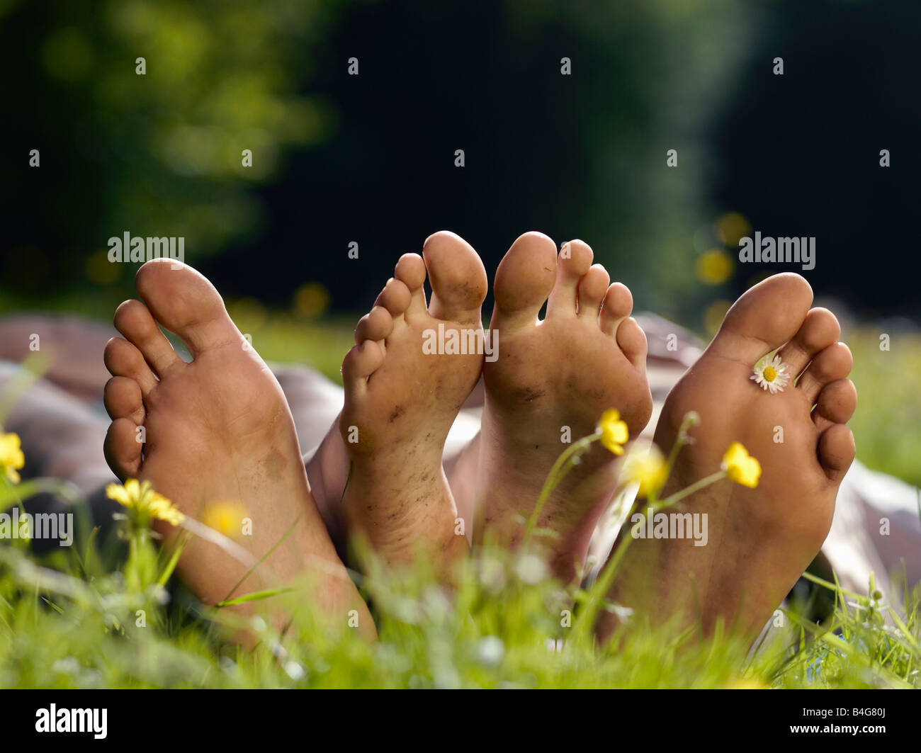 The soles of two people's bare feet, close up Stock Photo - Alamy