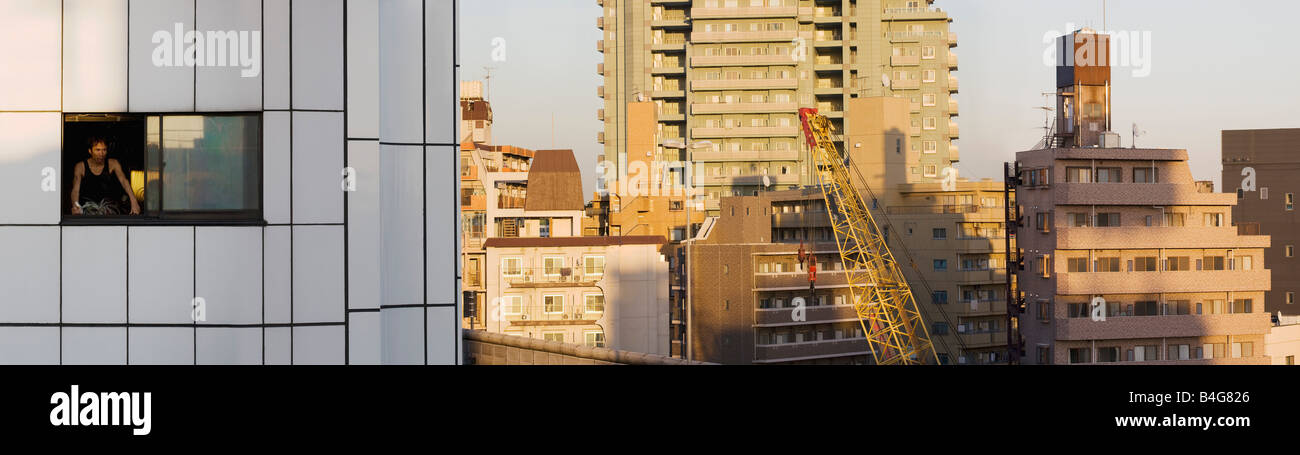 A man standing at an apartment window, Tokyo, Japan Stock Photo - Alamy