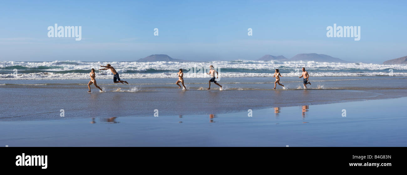 People running along a beach Stock Photo - Alamy