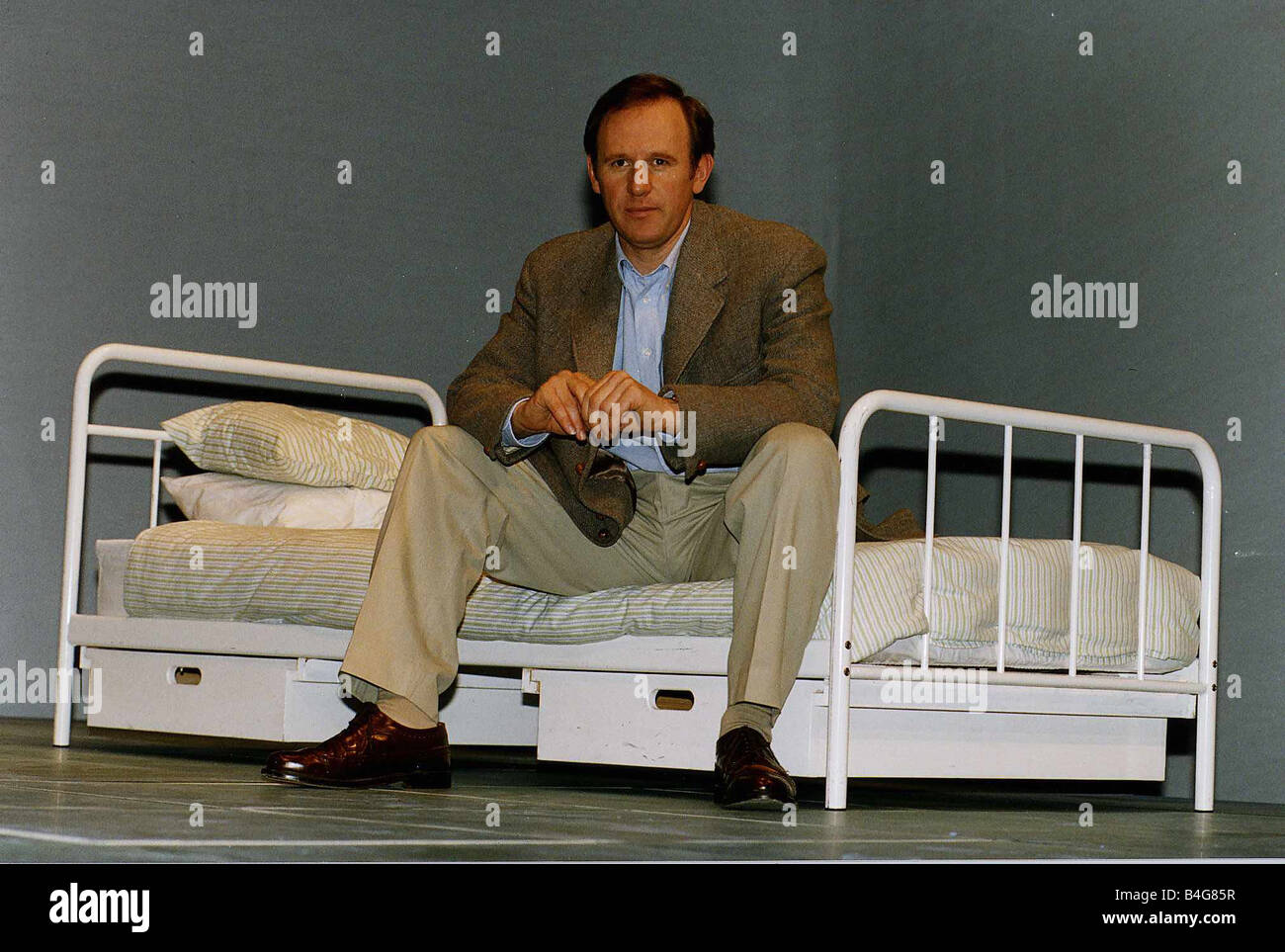 Peter Davison Actor in the Last Yankee sitting on a bed Stock Photo - Alamy