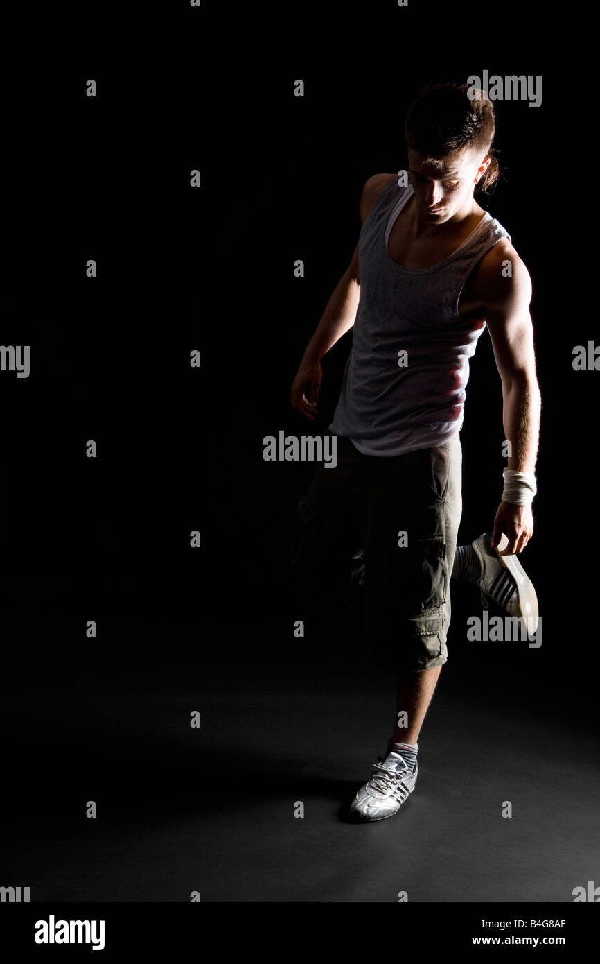 Portrait of a B-boy stretching Stock Photo - Alamy