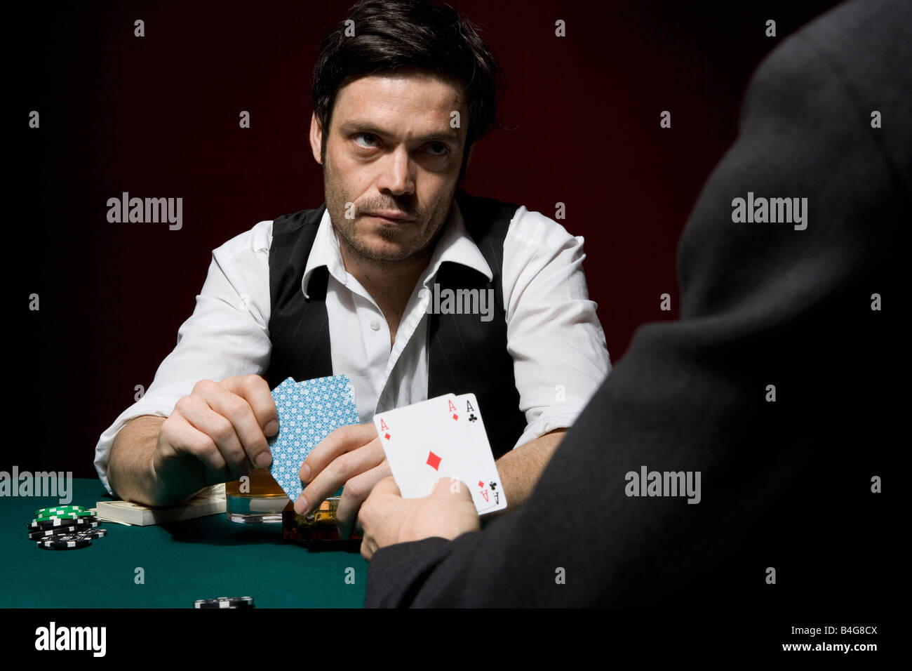 Two men playing poker at a high stakes game Stock Photo - Alamy