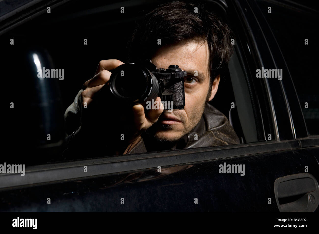 A man doing surveillance with a camera from his car Stock Photo - Alamy