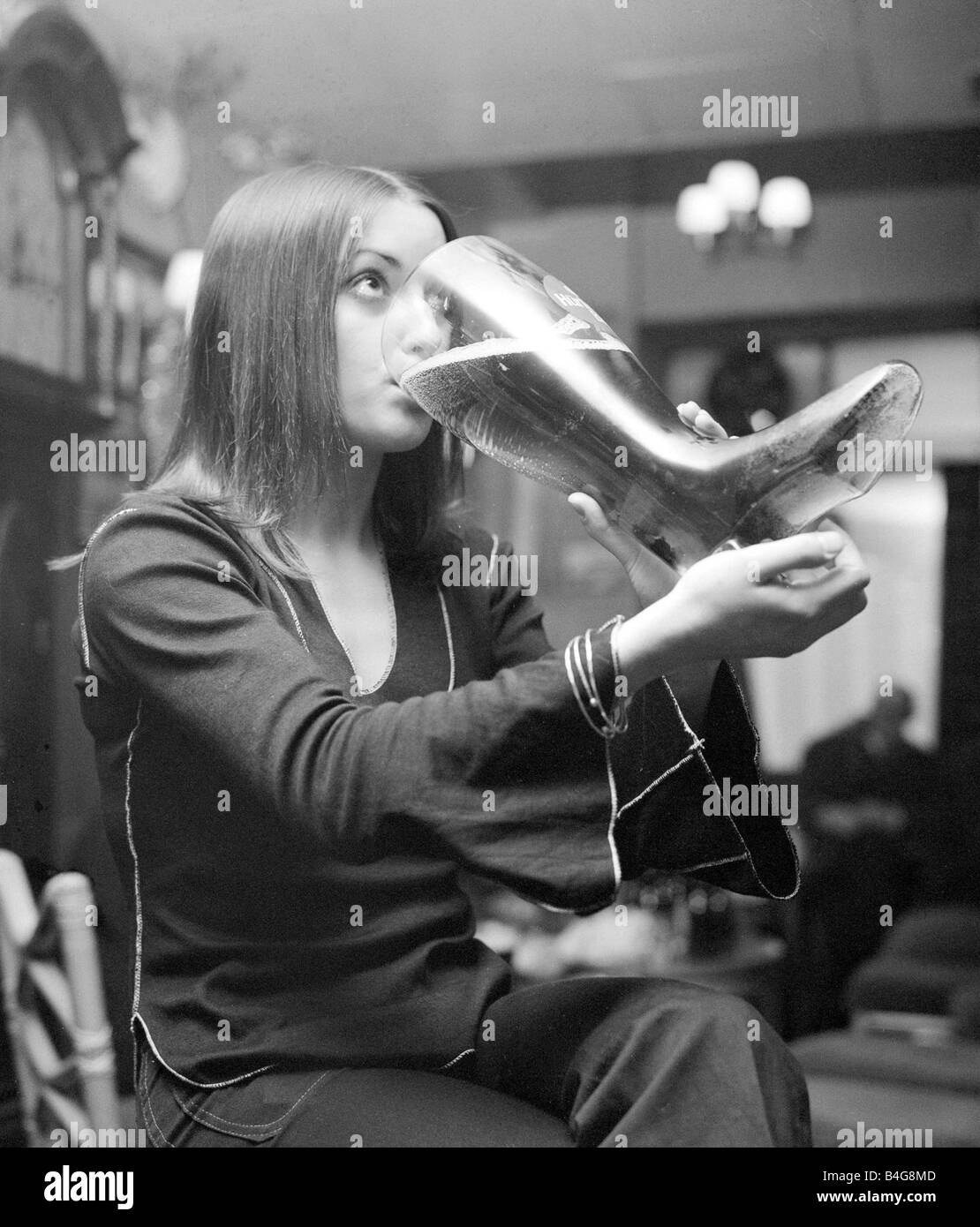 Woman drinking from a glass boot holding nearly 5 pints of lager Stock ...